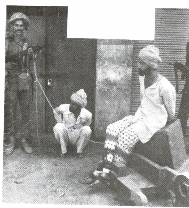 Two Sikh youths are being taken away with their hands tied behind their ...